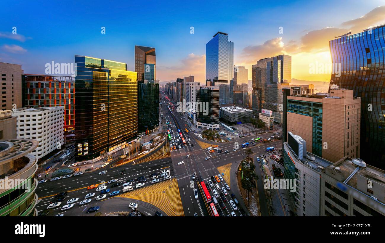 Panorama of Traffic speeds through an intersection at sunset in Gangnam ...