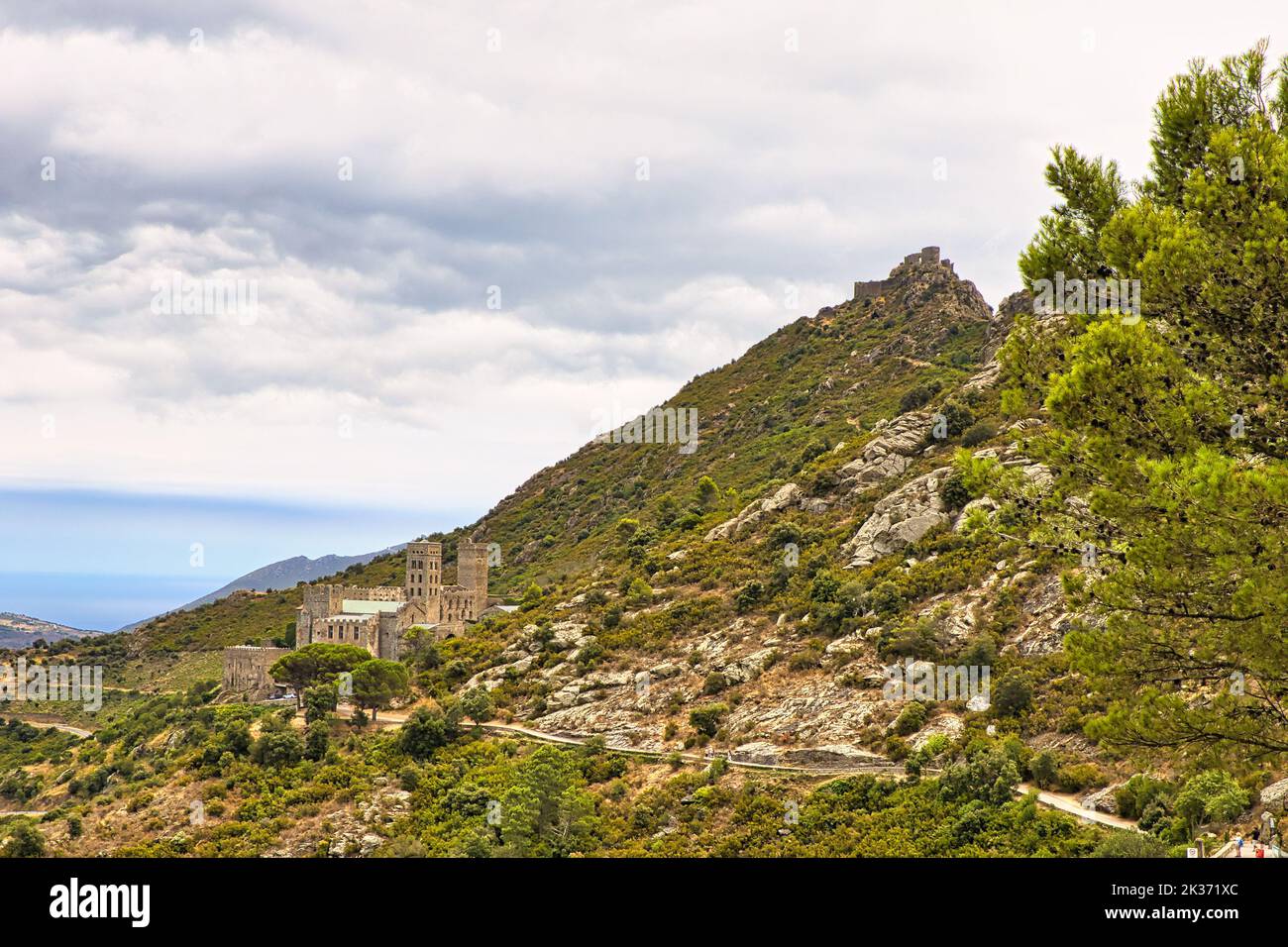 Monastery on a hillside with ruins of a castle on top Stock Photo - Alamy