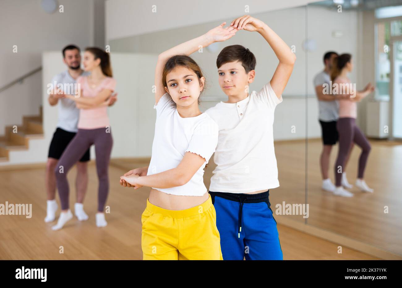 Teen sister and brother learning to dance waltz in pair in studio Stock ...