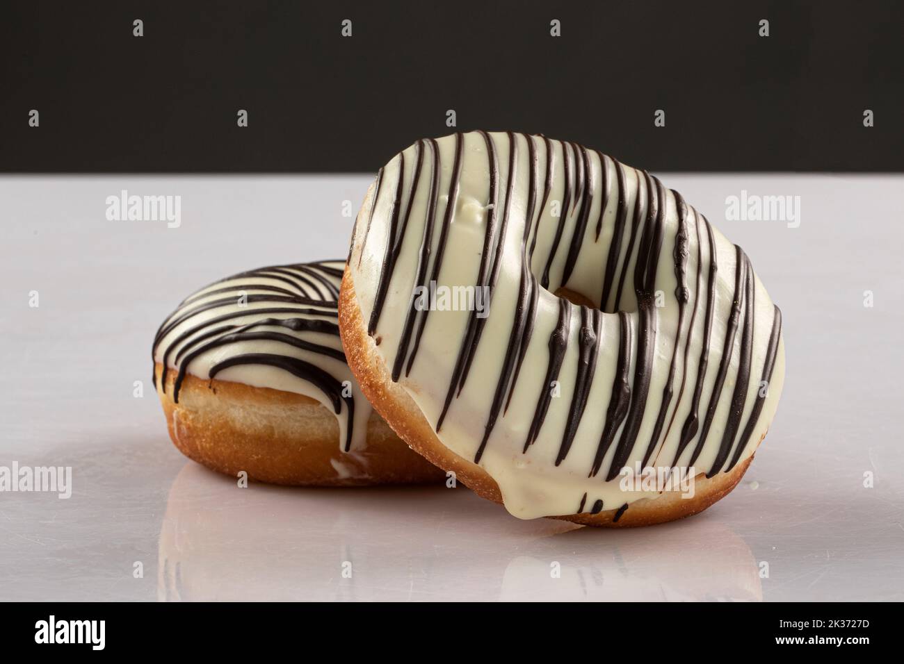 Traditional American donuts with chocolate and pink icing and sprinkles ...