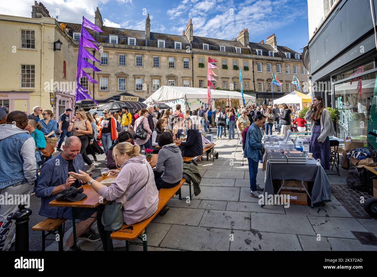 People eating at outdoor tables at the Great Bath Feast street food ...