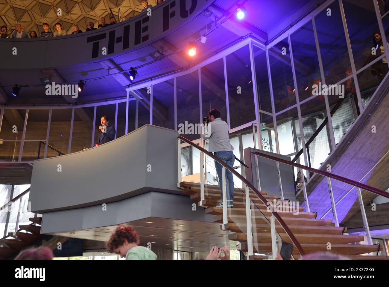 Photographer taking a photo of a speaker at a public event Stock Photo ...