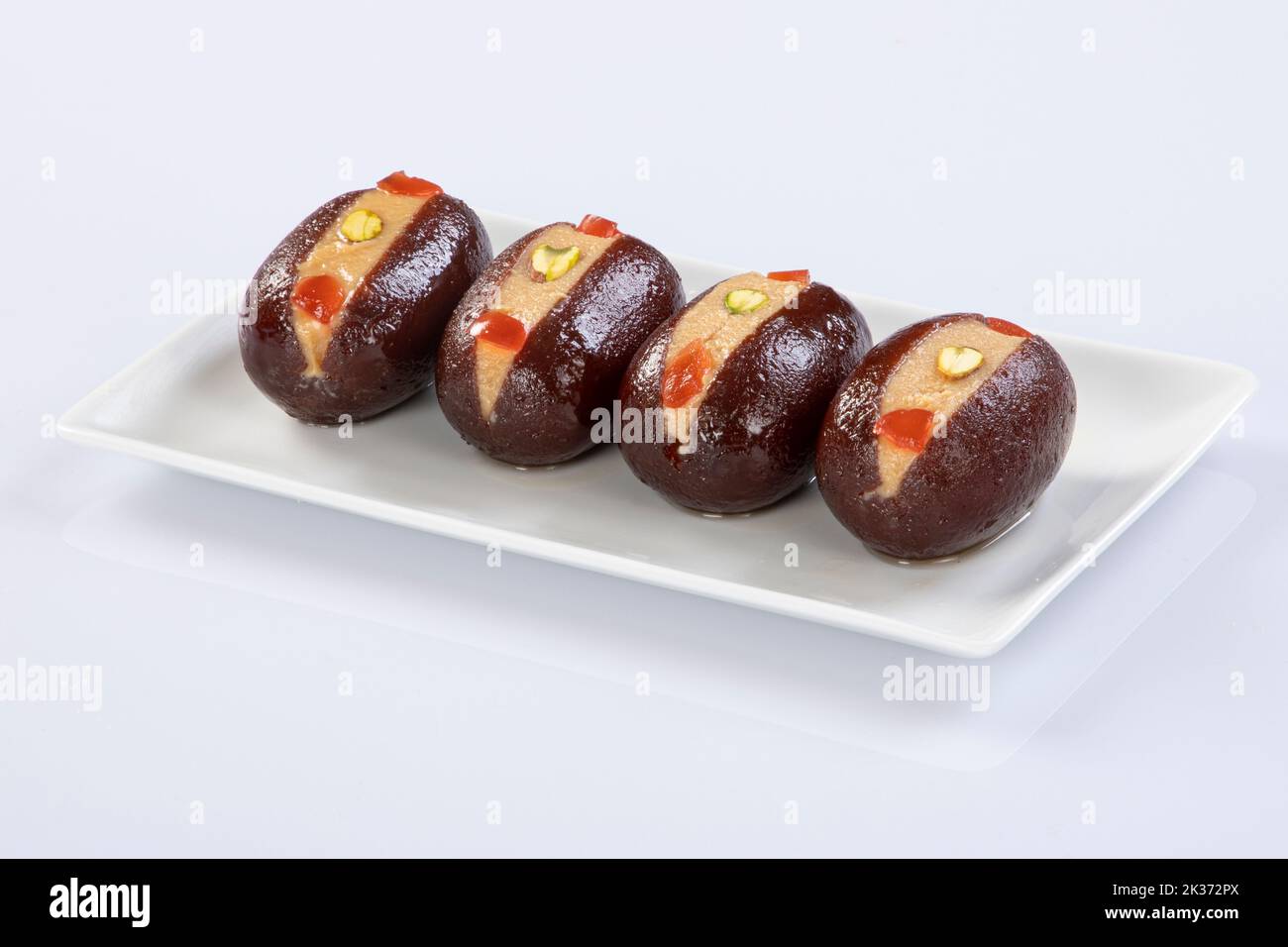 Gulab Jamun with almond and saffron served in white bowl. Indian sweet ...