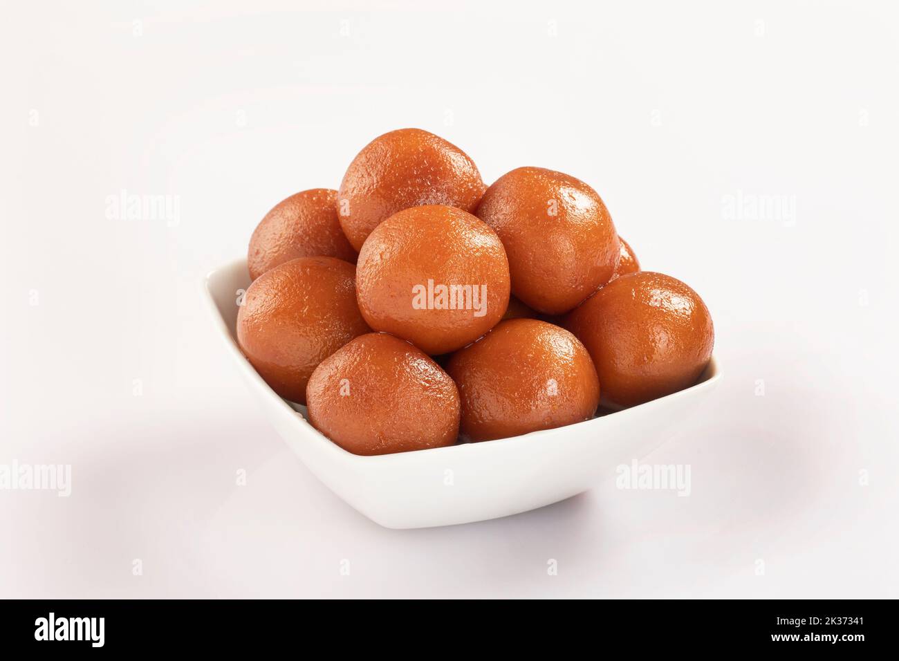 Gulab Jamun with almond and saffron served in white bowl. Indian sweet ...