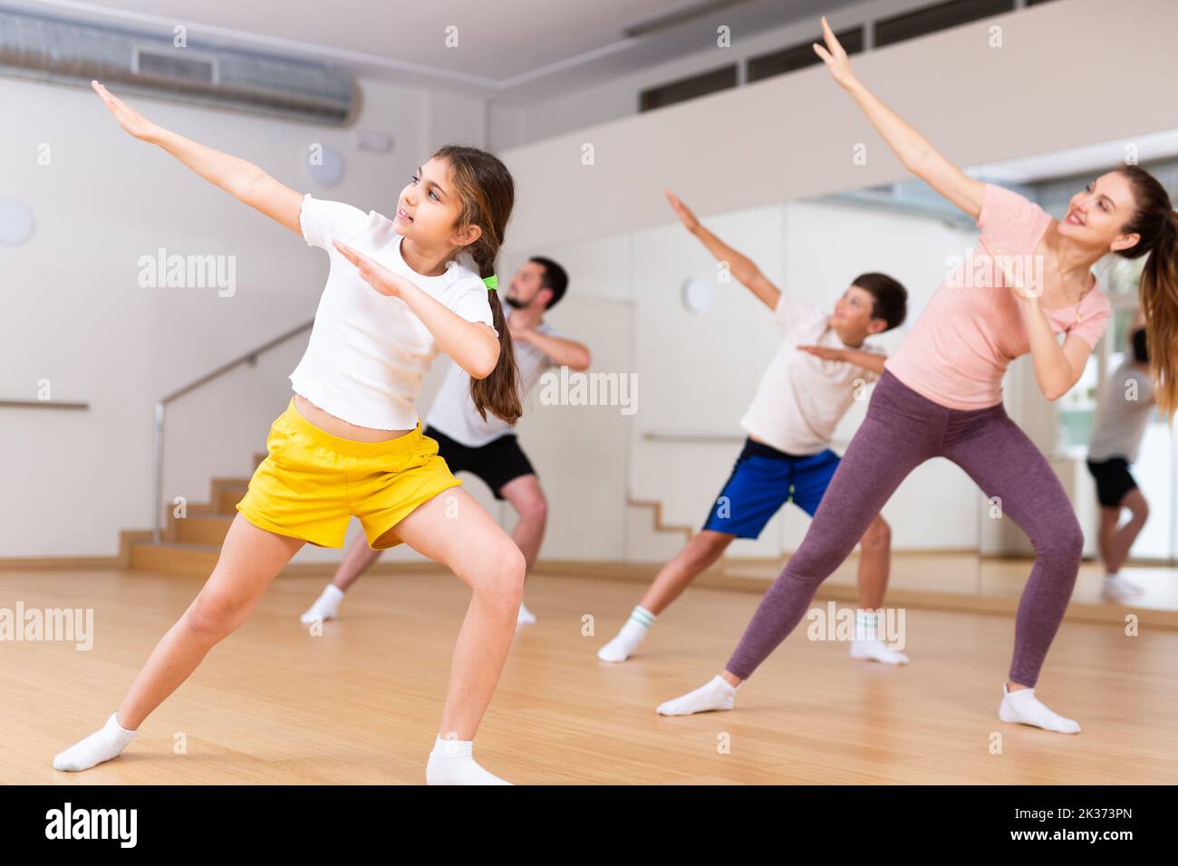 Girl exercising during family dance class Stock Photo - Alamy