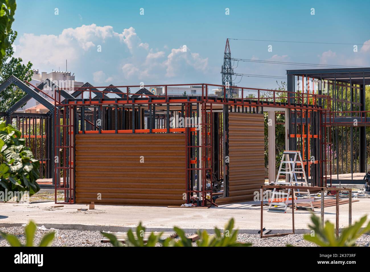 Metal frame of newly built building. Construction of a new tiny house ...