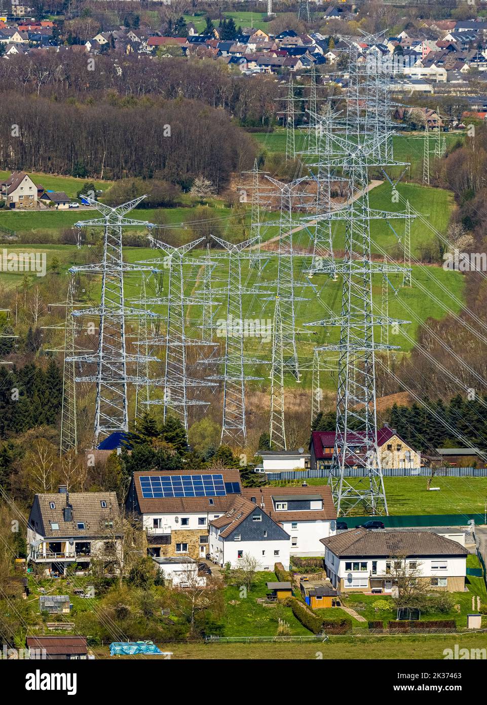 Aerial view, power poles with power lines and residential buildings of ...
