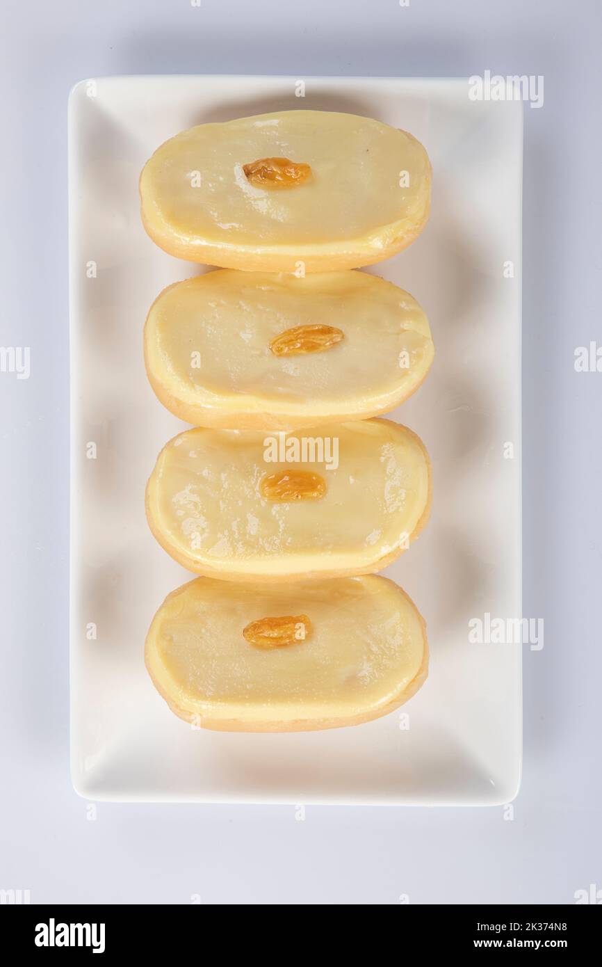 Plate with traditional Indian sweets – laddu, gulab jamun, gujiya ...