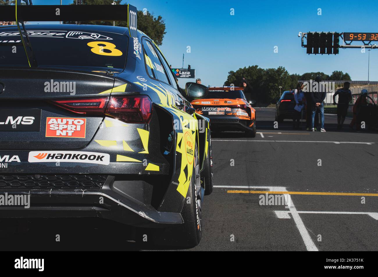 Rear view of racing car Audi RS3 standing in racetrack starting grid ...