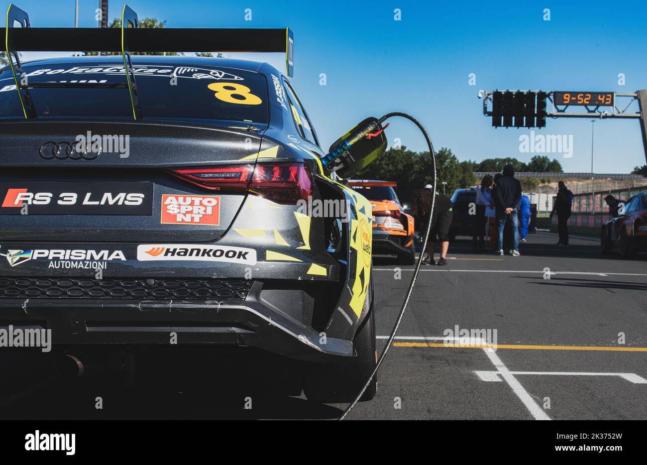 Rear view of racing car Audi RS3 standing in racetrack starting grid ...
