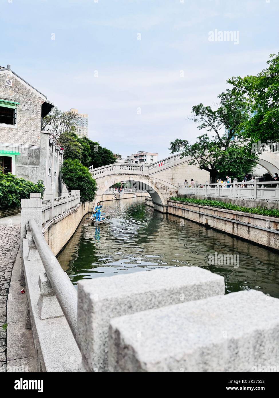 A vertical of a social worker cleaning the old water town in Guangzhou ...