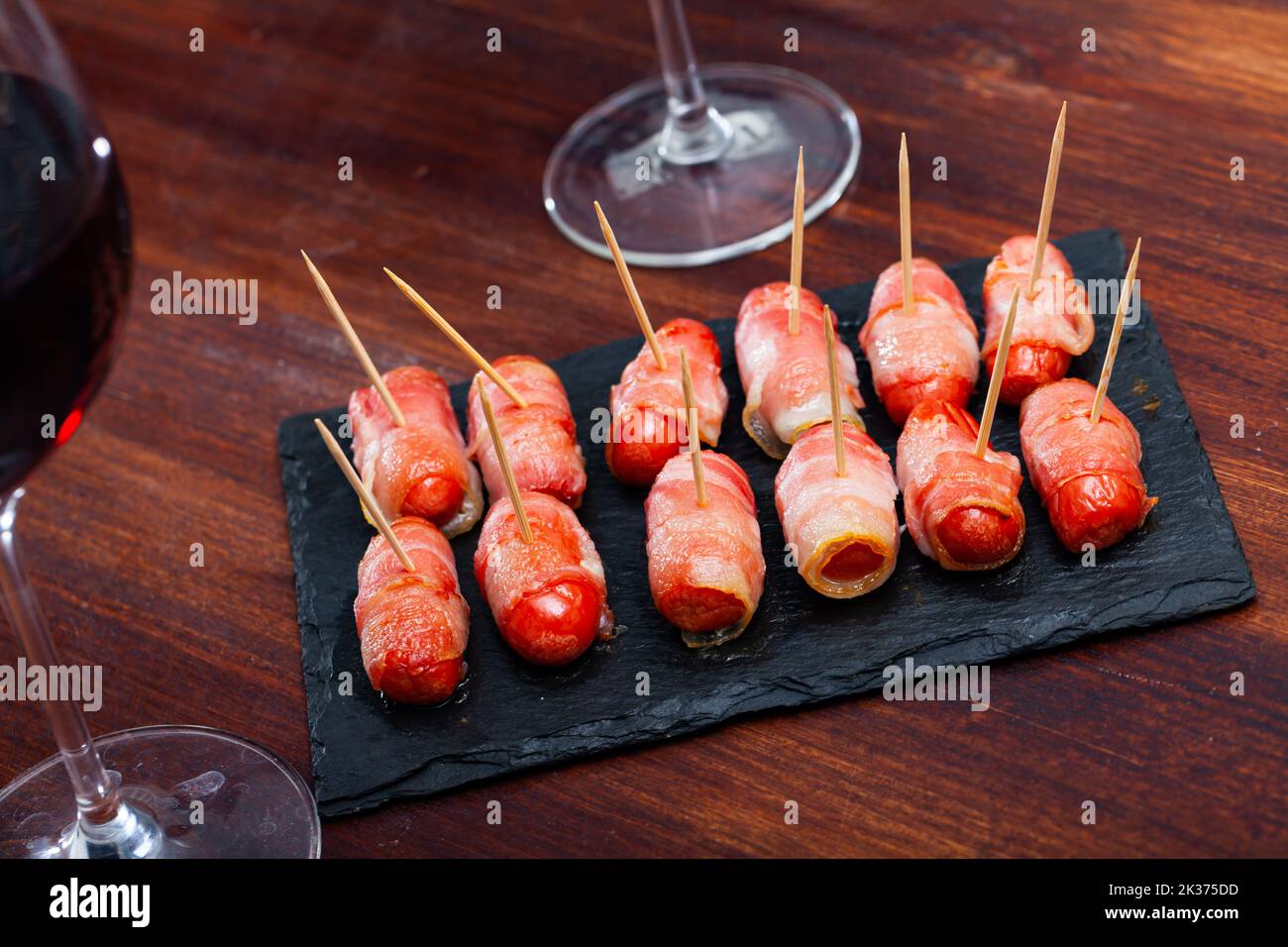 Spanish tasty meal rolled in bacon sausages at plate Stock Photo - Alamy