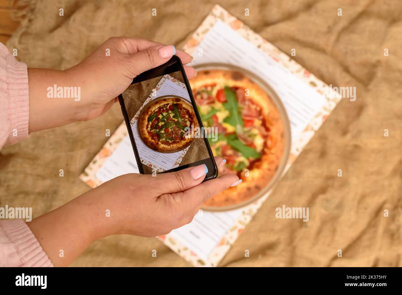 Photographing food. Hands taking picture of delicious pizza with ...