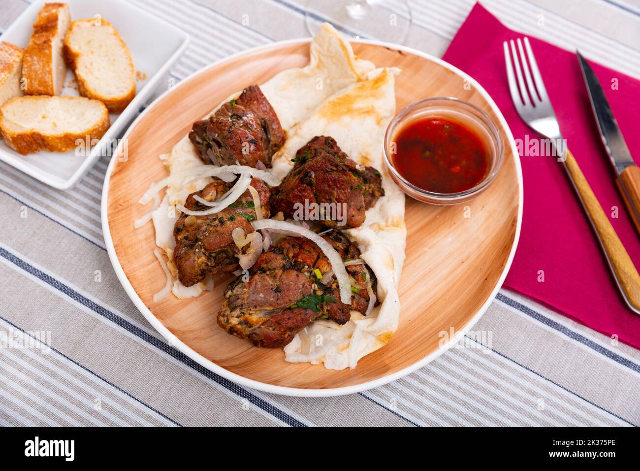 Grilled pork meat shashlik with marinated onion Stock Photo - Alamy