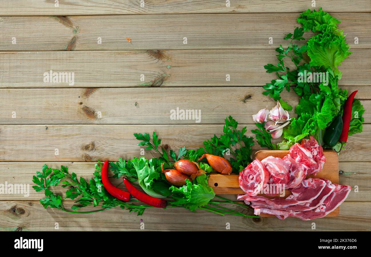 Raw mutton, vegetables, herbs on wooden surface Stock Photo - Alamy