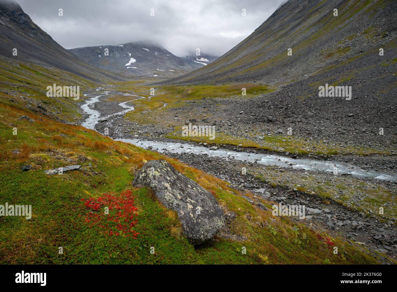 Wild river flowing through harsh, remote arctic valley on a cloudy ...