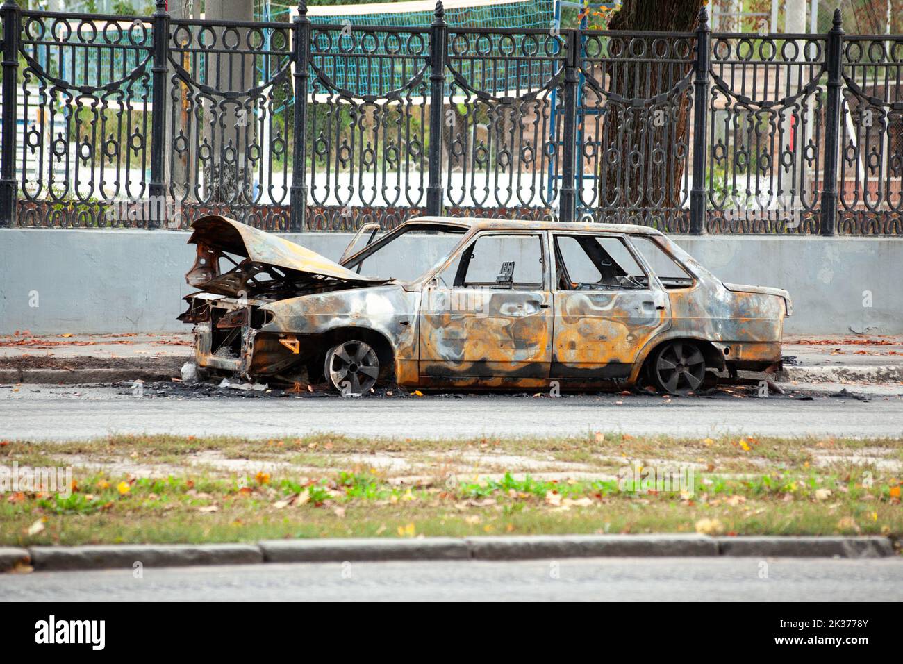 Burnt car body on the street. The car after the fire. Burned out car on ...