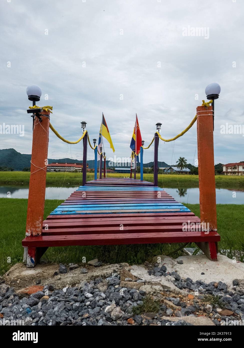 Colourful wooden bridge looking at the beautiful paddy field in Perlis ...