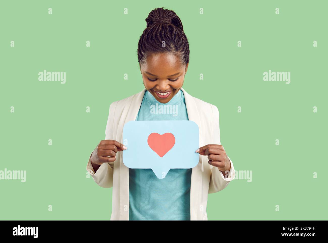 Smiling black woman show paper with heart Stock Photo - Alamy