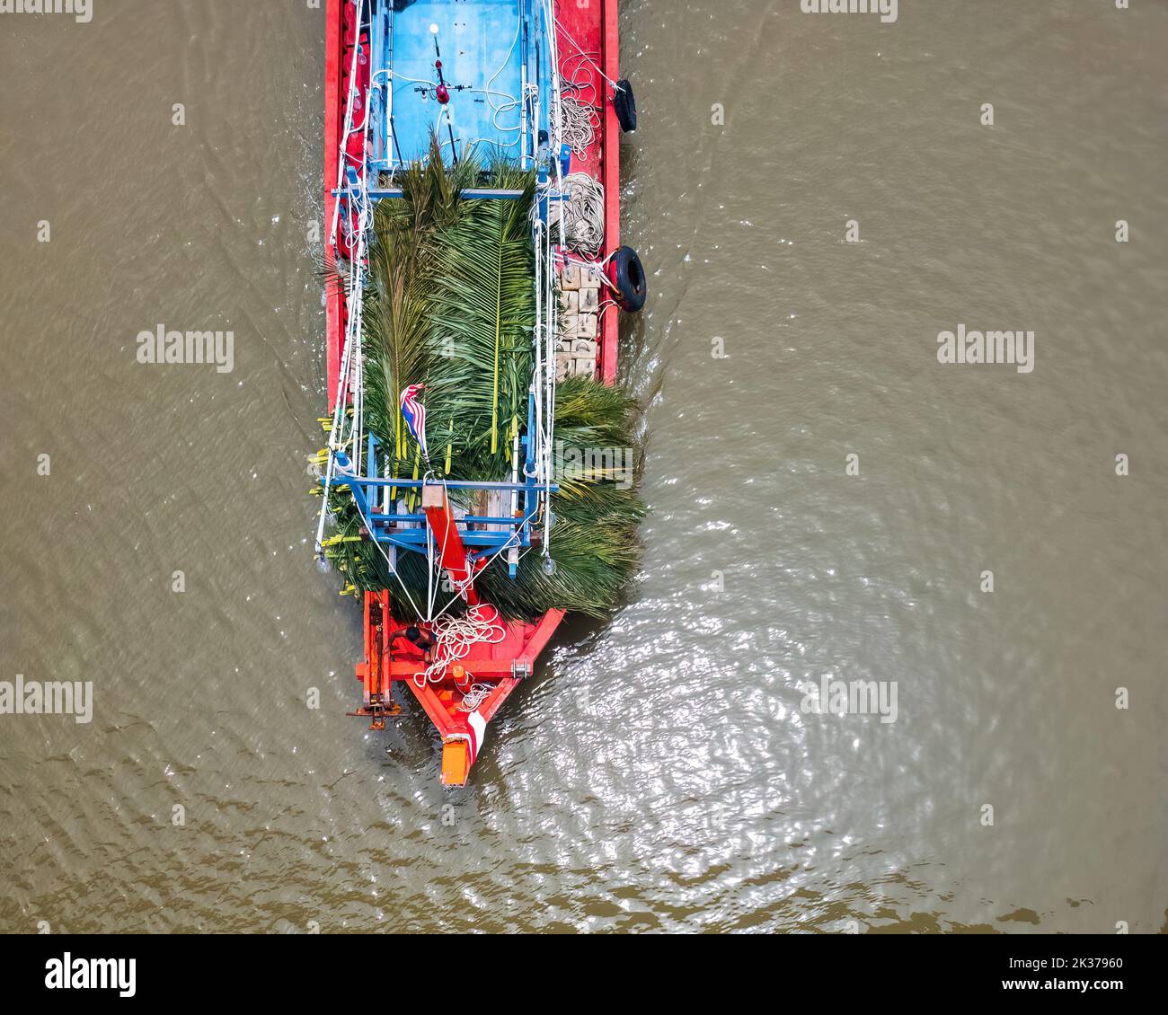 Top view of a boat moving with leaves on the river. View from the ...