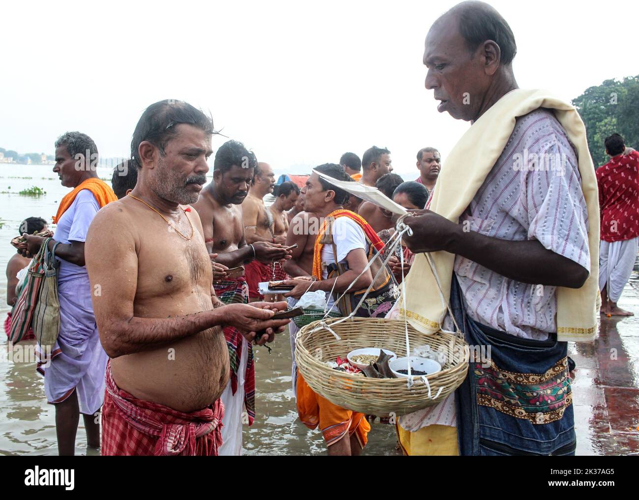 People of Kolkata are performing Tarpana at Ganga river. Tarpana is a ...