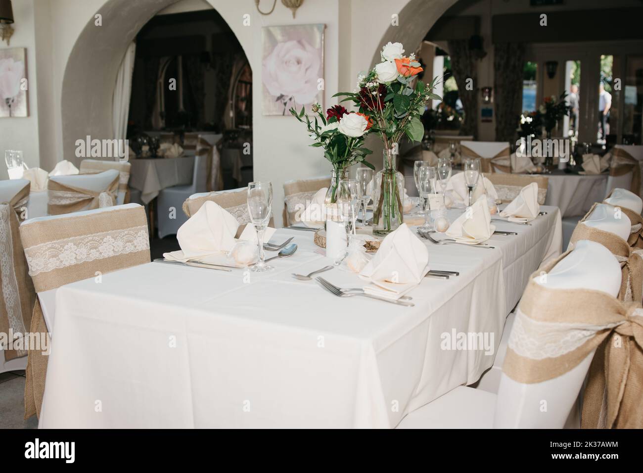 Rustic Wedding Reception Top Table seating with glasses, cutlery and ...