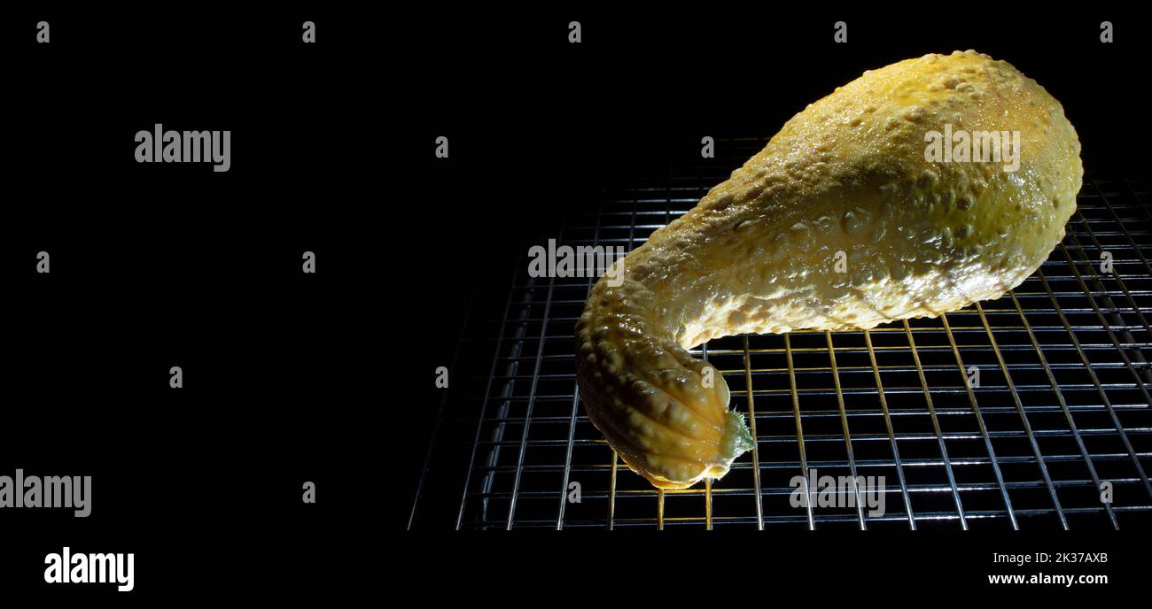 Copy space next to a yellow squash on a metal shelf Stock Photo - Alamy