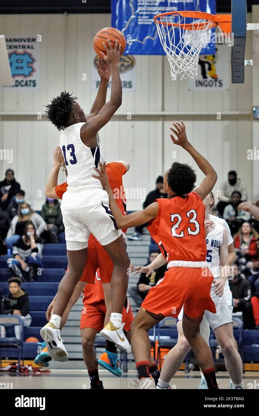 A vertical shot of basketball players under the basket in a high school ...