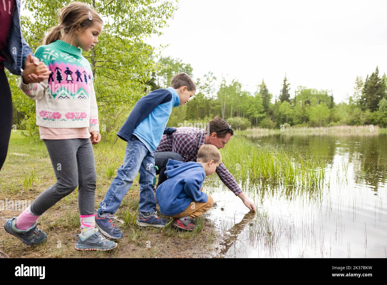 Child looking at reflection in water hi-res stock photography and ...