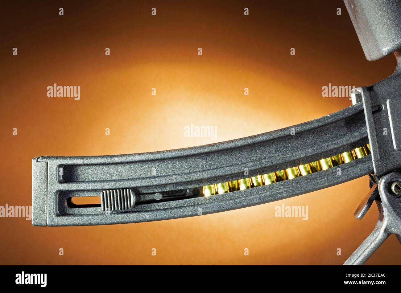 Rimfire rifle magazine fully loaded with brown background and copy ...