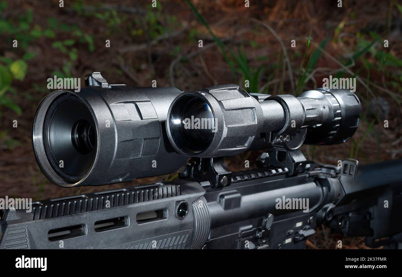 Night vision rifle scope on an assault rifle in the outdoors Stock ...
