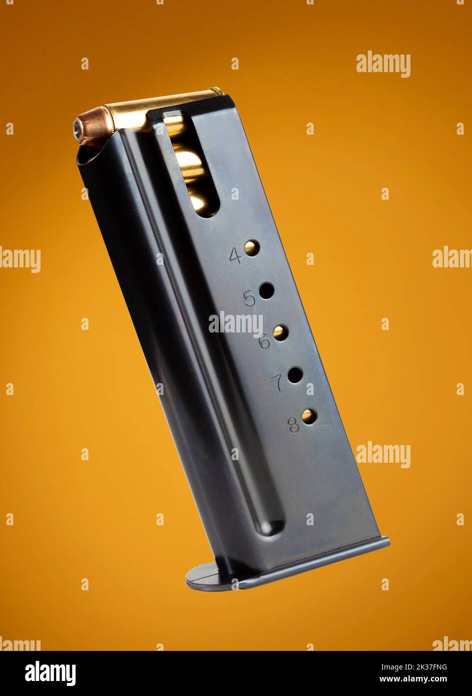 Pistol magazine with hollow points loaded on an orange background Stock ...