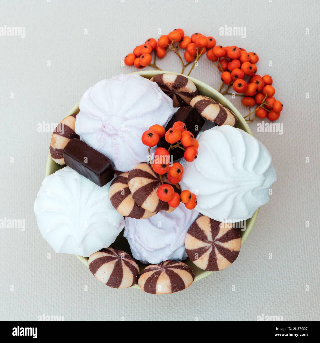 Sweet delicious dessert with forest pine cones and bunches of rowan ...