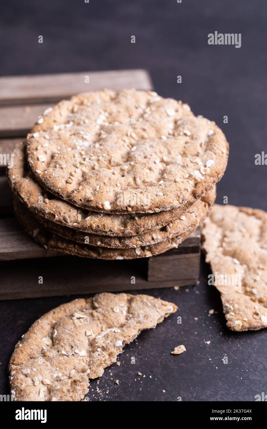 A vertical closeup shot of fresh cereal cookies on a table surface ...