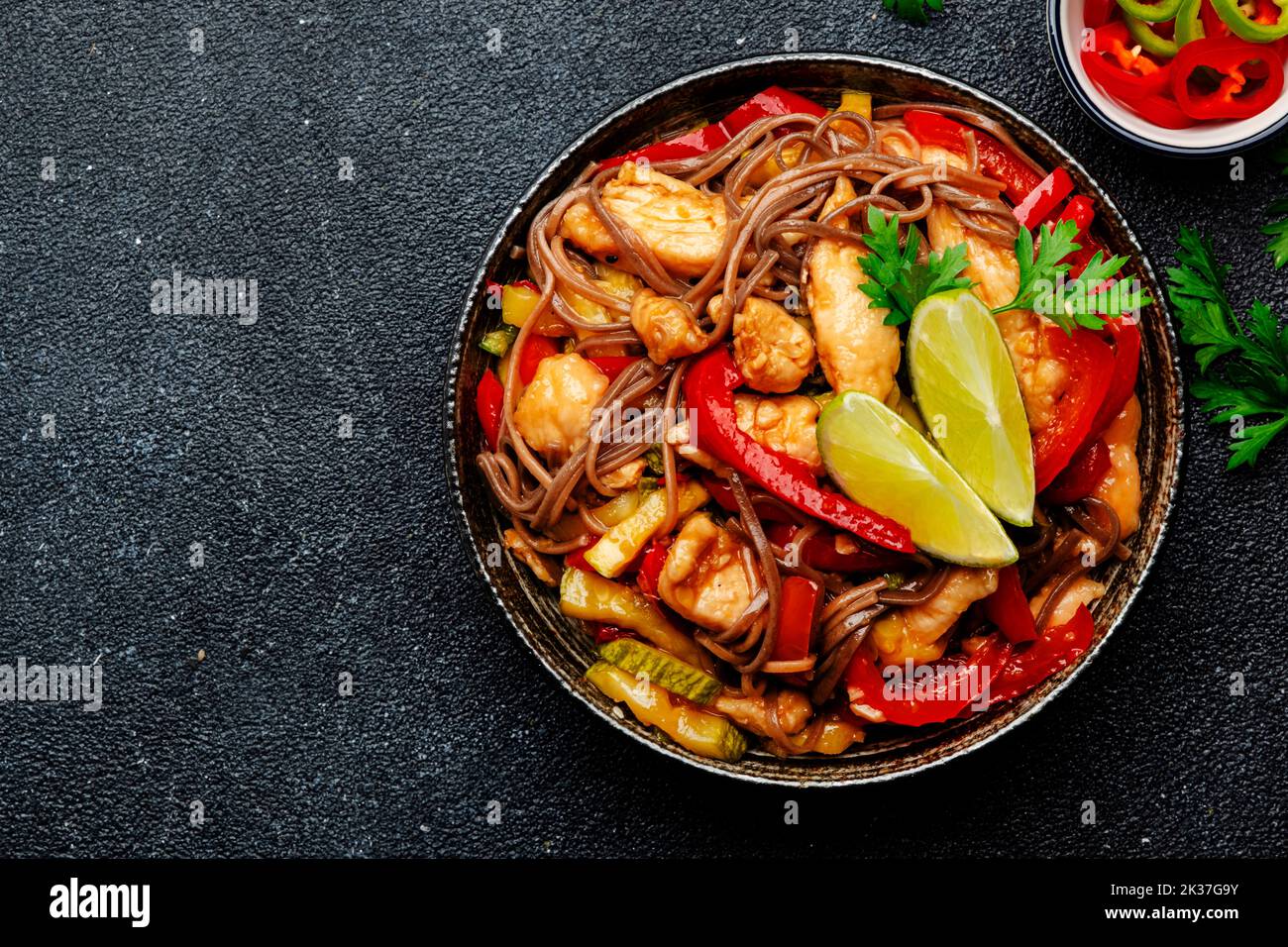 Asian cuisine, stir fry noodles with chicken and vegetables and sesame ...