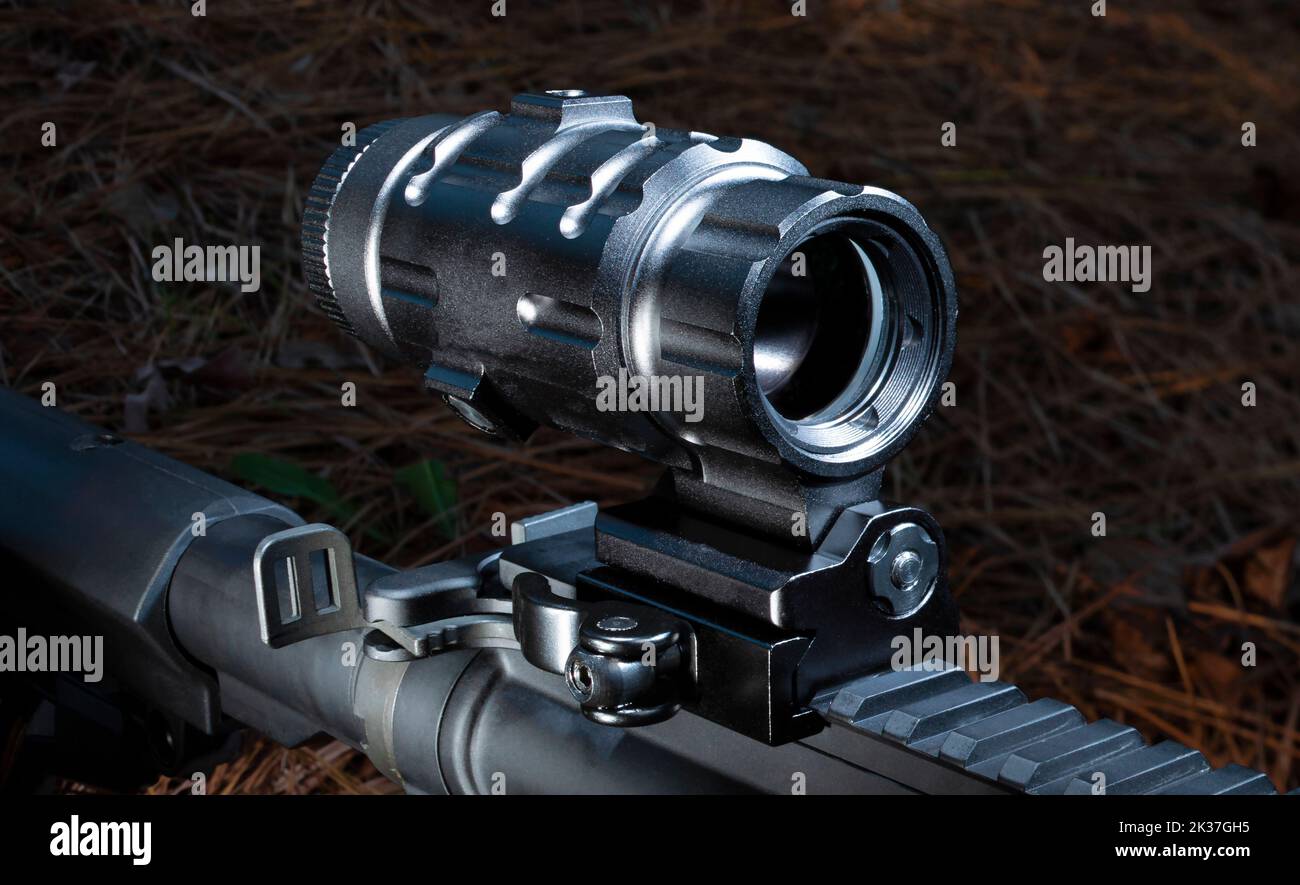 Assault rifle with a magnifier mounted in the outdoors Stock Photo - Alamy