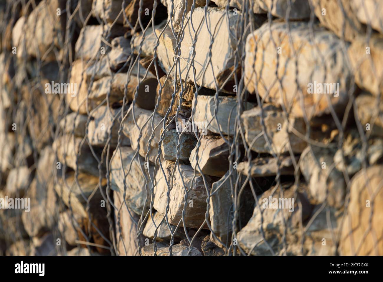 metal mesh on a stone wall. slope crumbling protection. High quality ...