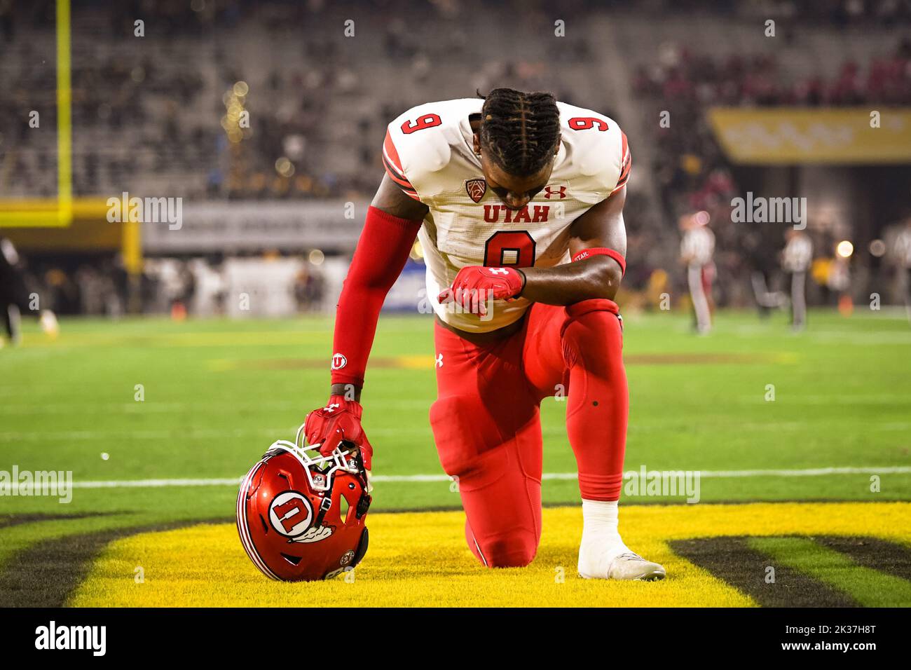 Utah Utes running back Tavion Thomas (9) kneels in prayer before an ...