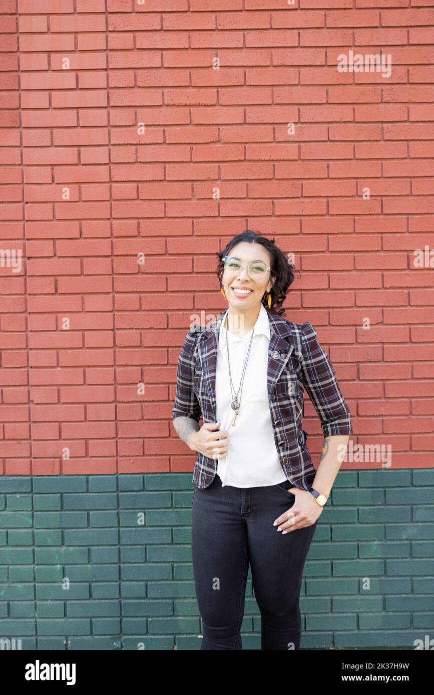 Woman brick wall happy hi-res stock photography and images - Alamy