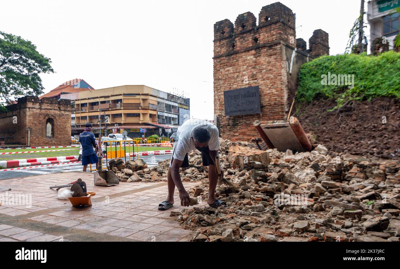 A worker from Chiang Mai Municipality sweeps damaged bricks of the ...