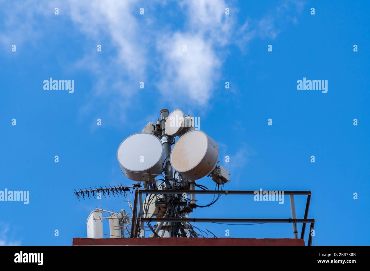 A telecommunication antenna on top of a building Stock Photo - Alamy