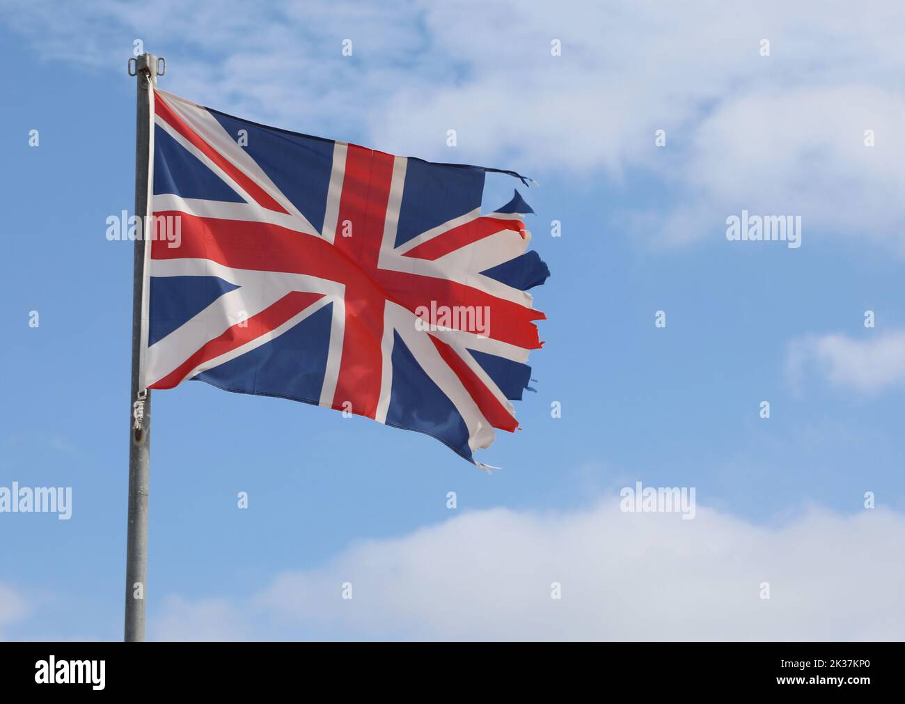 frayed English flag ruined due to bad weather Stock Photo - Alamy