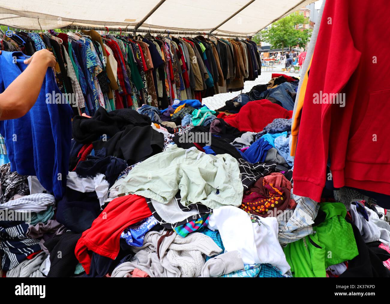 used clothes in the outdoor flea market stall with many bargains Stock ...