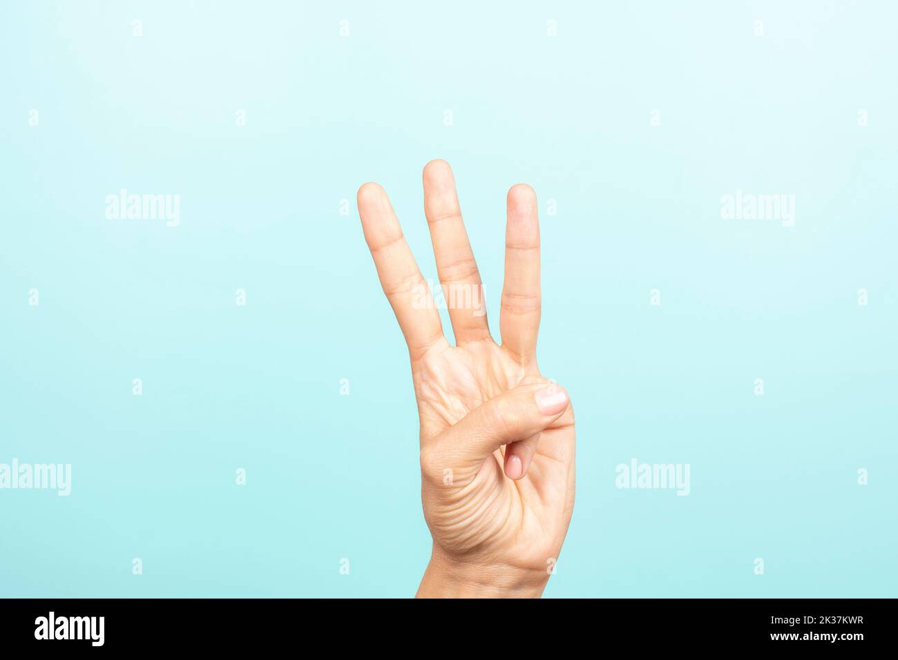 Hand gesture. Female hand shows number three. Woman hand pointing up ...