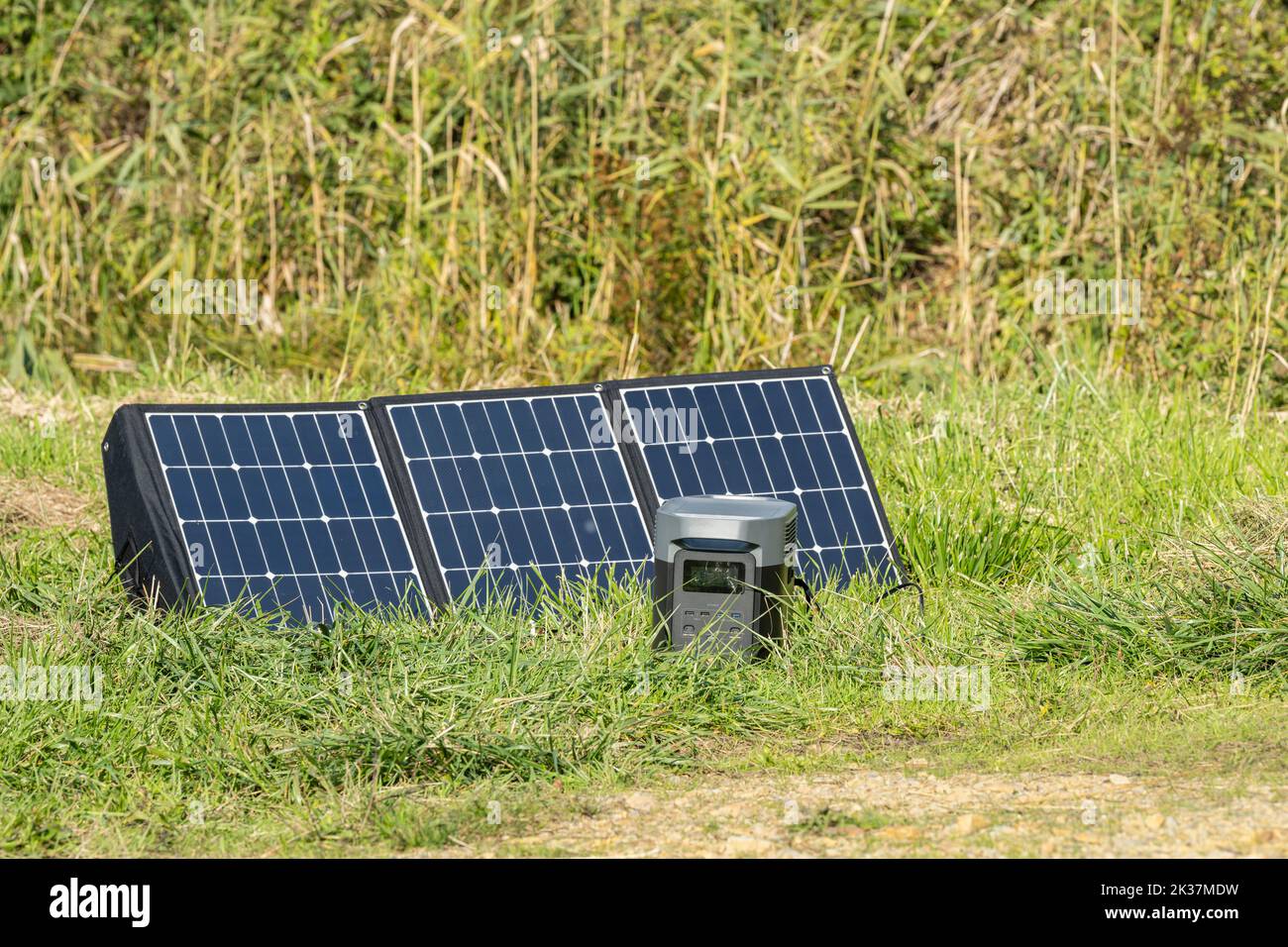 A foldable solar panel with a modern power station to store the ...