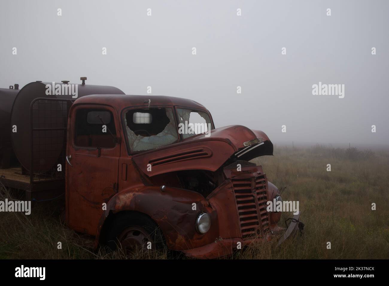 A rusty abandoned old broken down truck on a misty field Stock Photo - Alamy