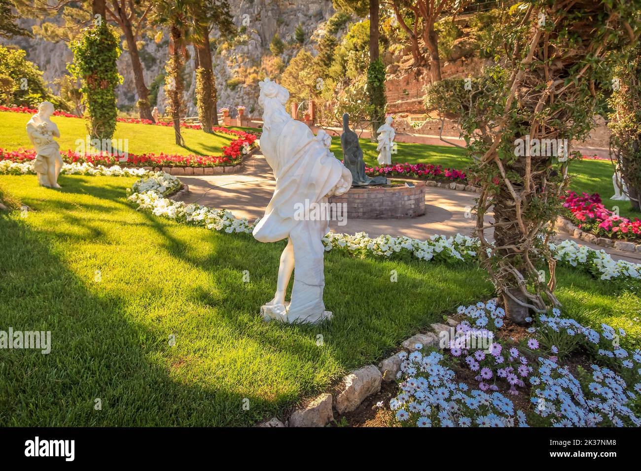 Idyllic public park at springtime with seat bench in Capri island ...