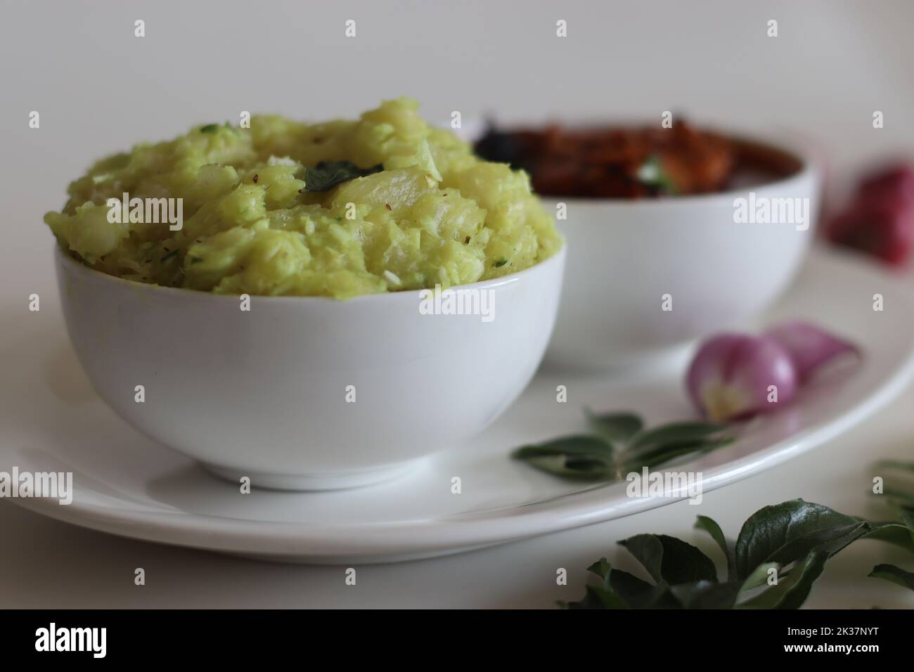Mashed tapioca served with pomfret fish curry. Boiled and strained ...