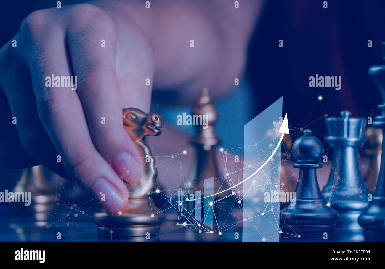 Hand of businessman holding gold king chess on stock market or forex ...