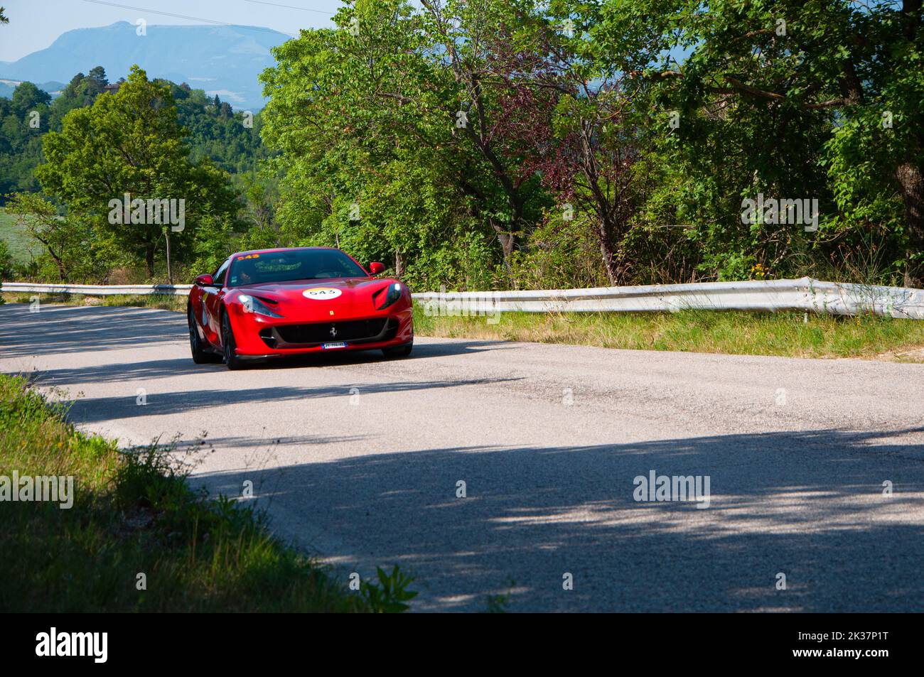 A red Ferrari 812 Superfast captured in a car racing rally Stock Photo ...